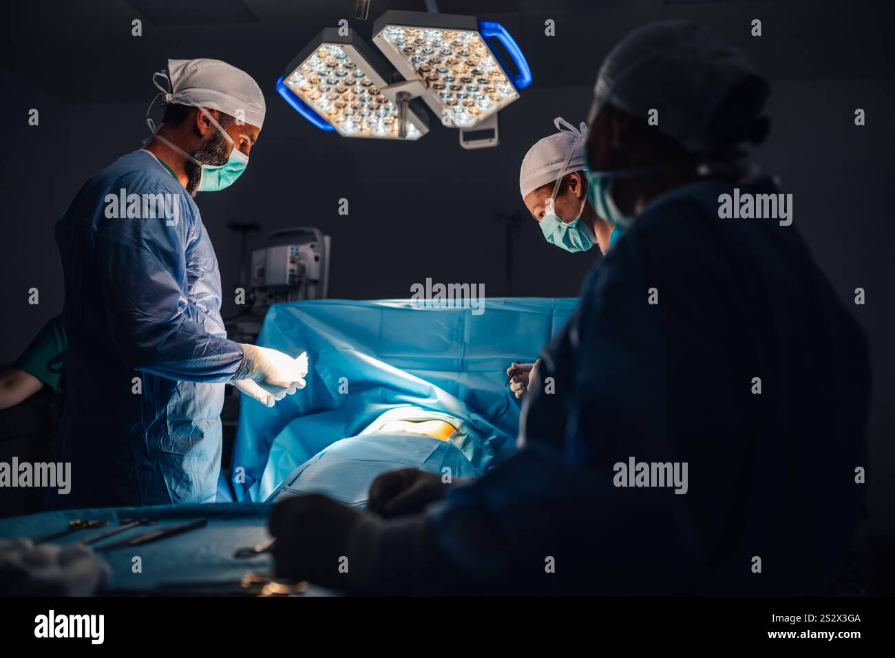 A dedicated team of surgeons and medical professionals performing an ...