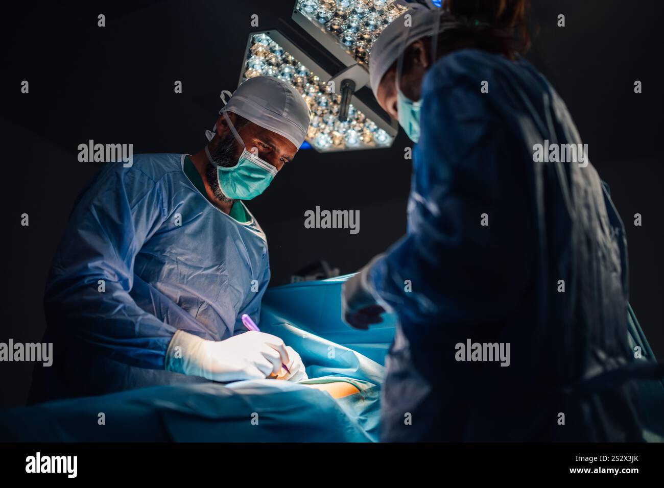 The photograph depicts surgeons in the midst of conducting a detailed ...