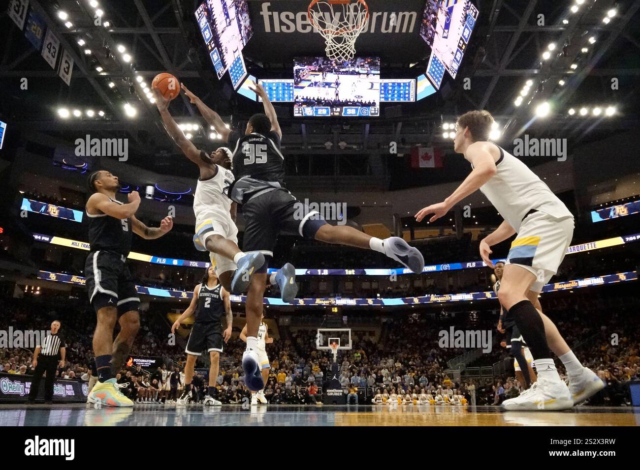 Marquette's Chase Ross shoots with Georgetown's Thomas Sorber defending ...
