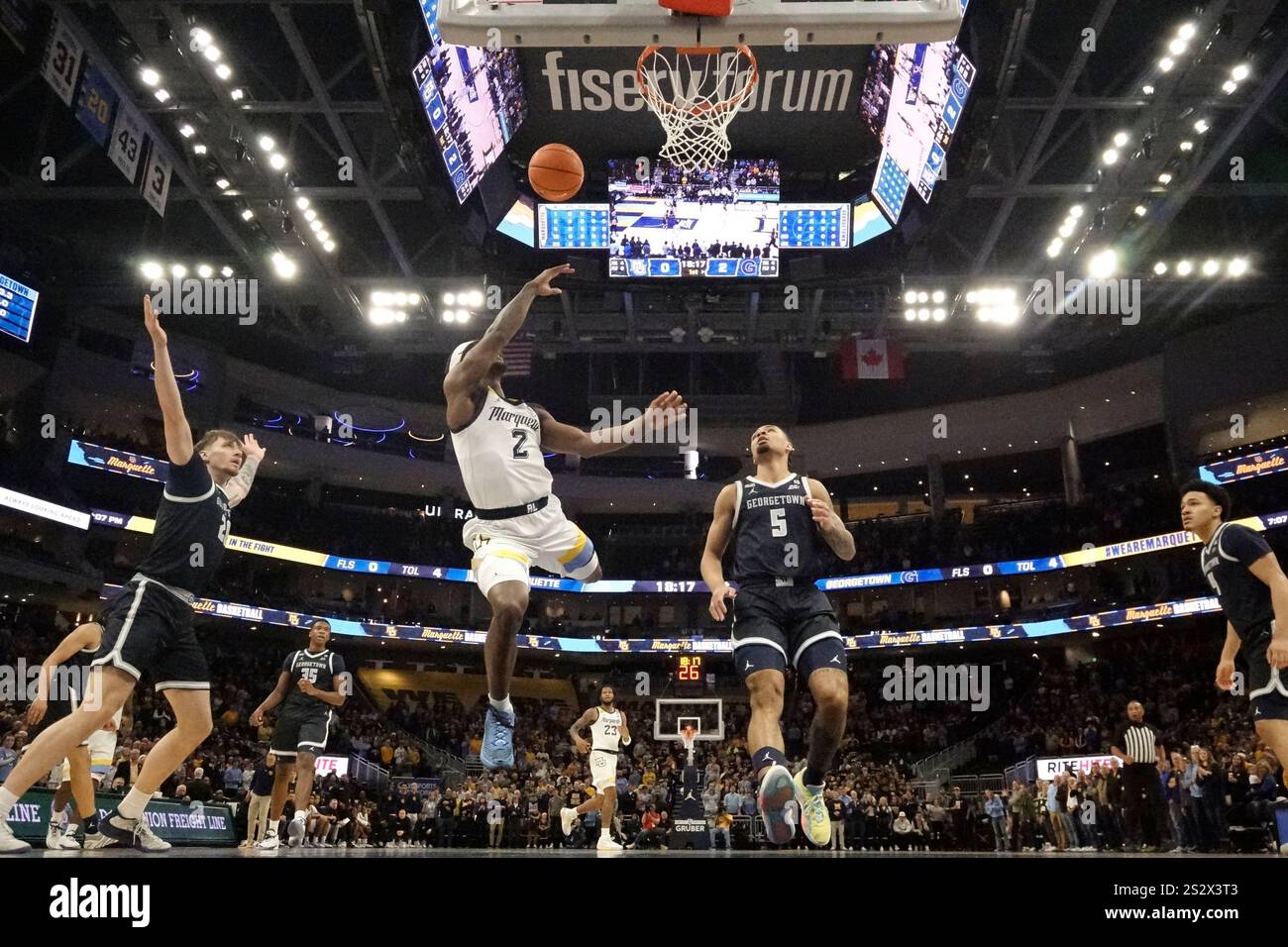 Marquette's Chase Ross shoots in front of Georgetown's Micah Peavy ...