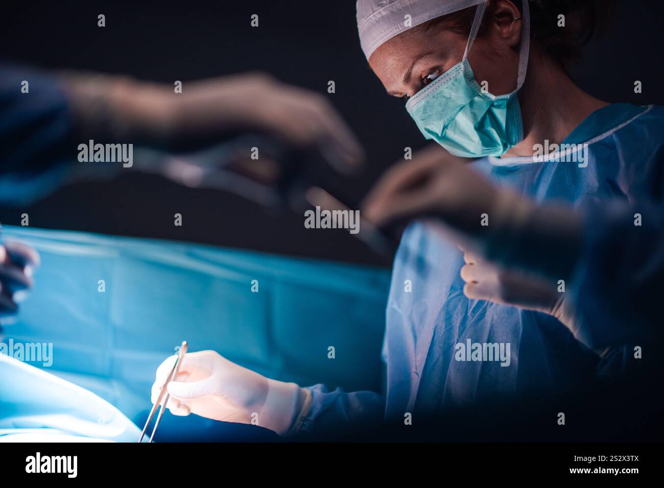 This image depicts surgeons in the midst of a complex surgical ...
