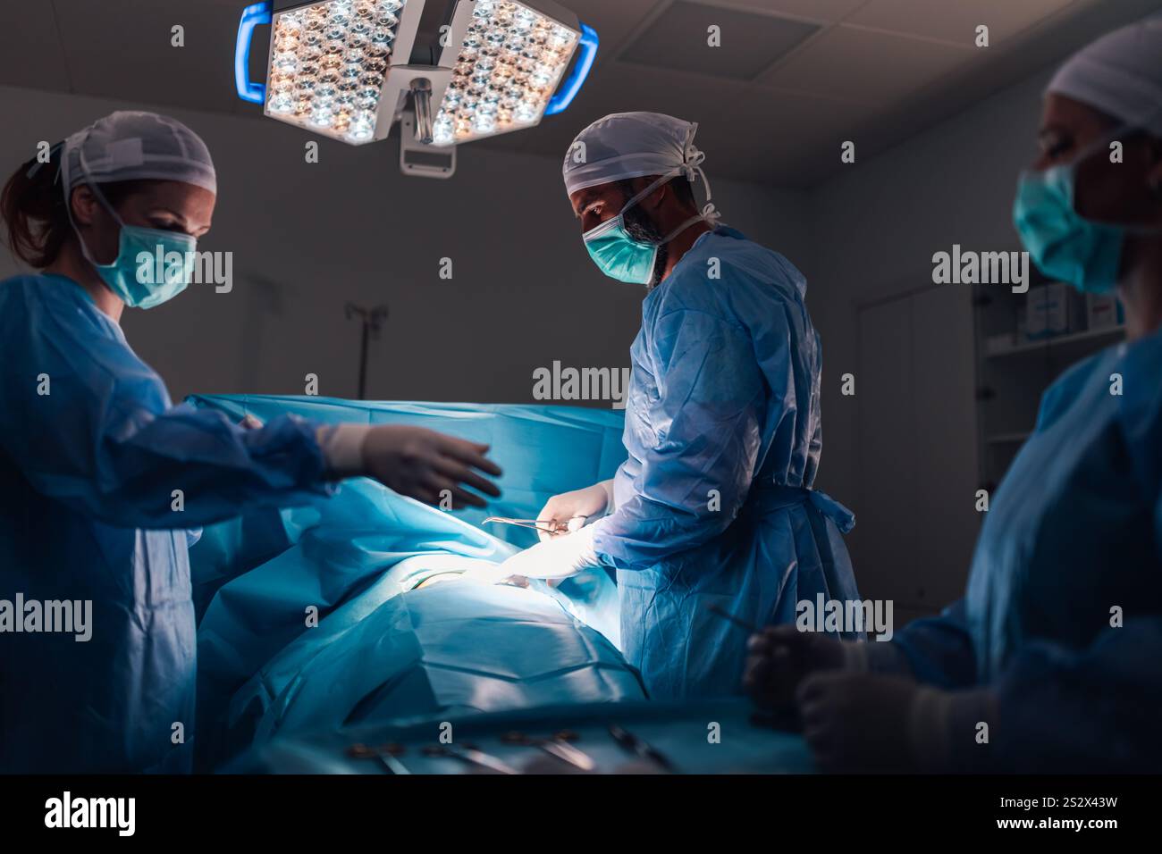 A team of medical professionals operates collaboratively in a modern ...