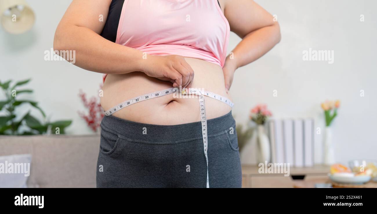 Measuring weight loss progress overweight individual home lifestyle content comfortable ...