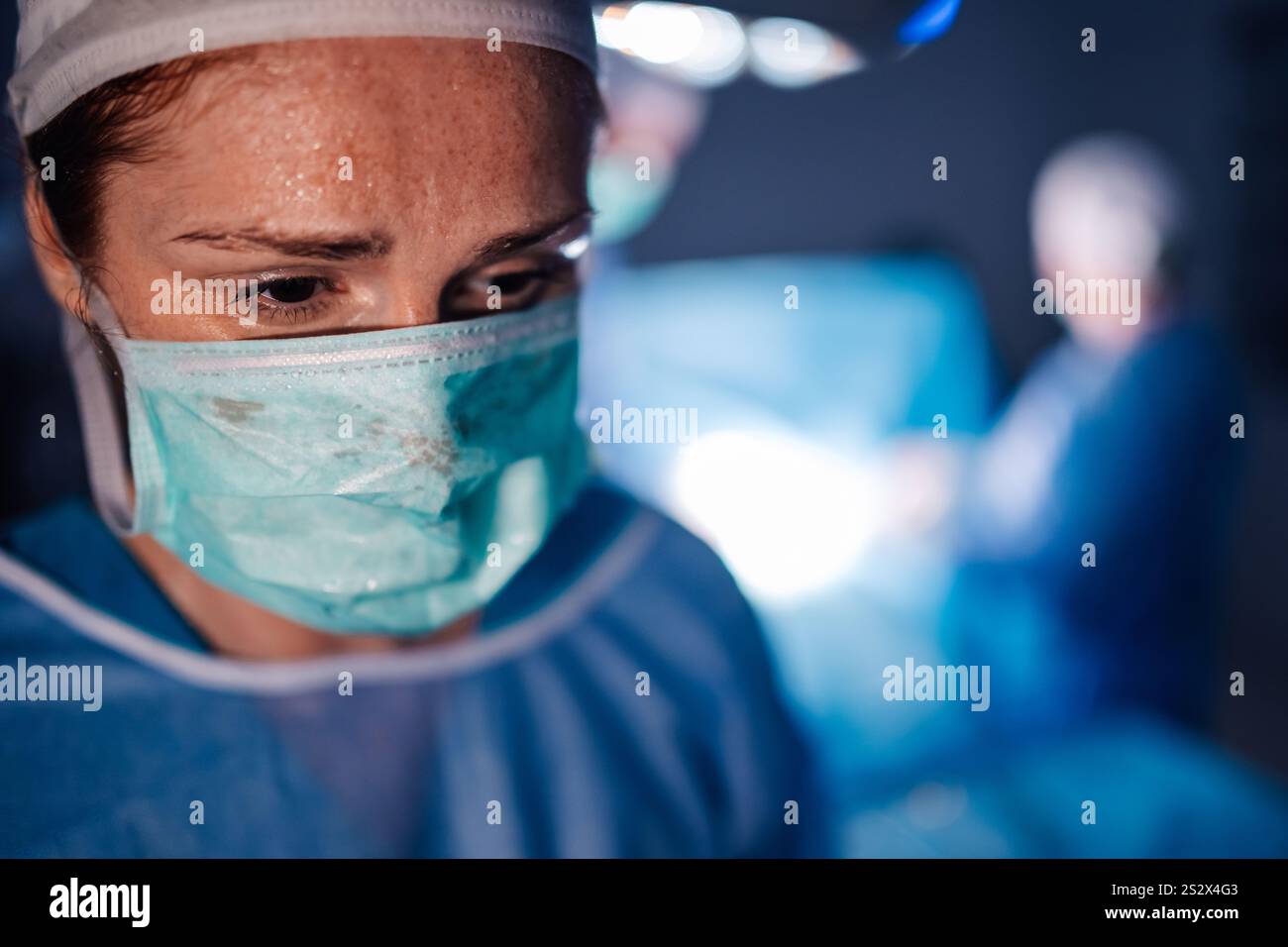 A medical team, focusing on a successful surgical procedure, is in an ...