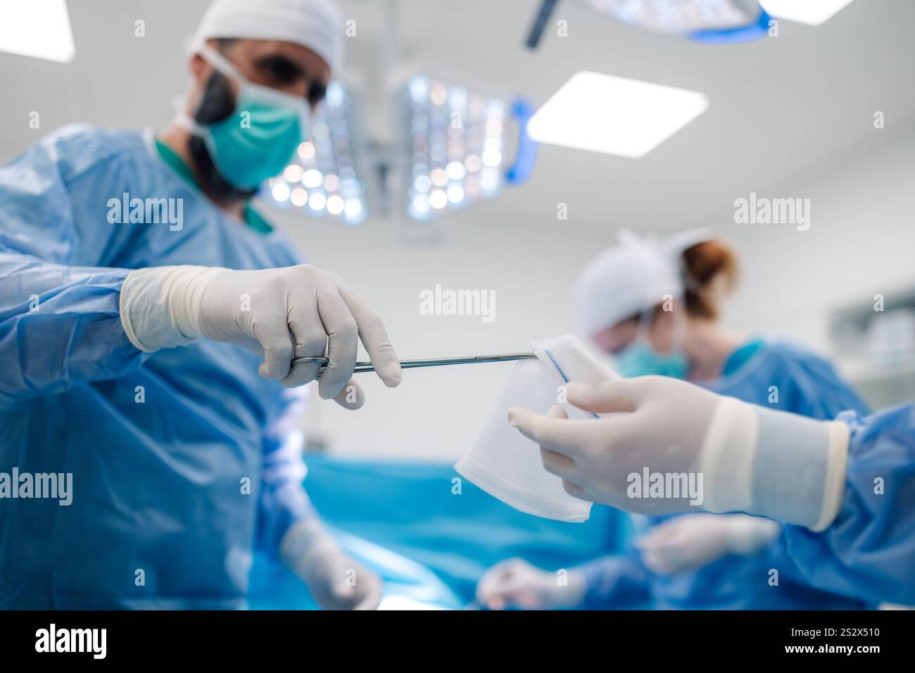 The photograph captures the precision and concentration of medical ...