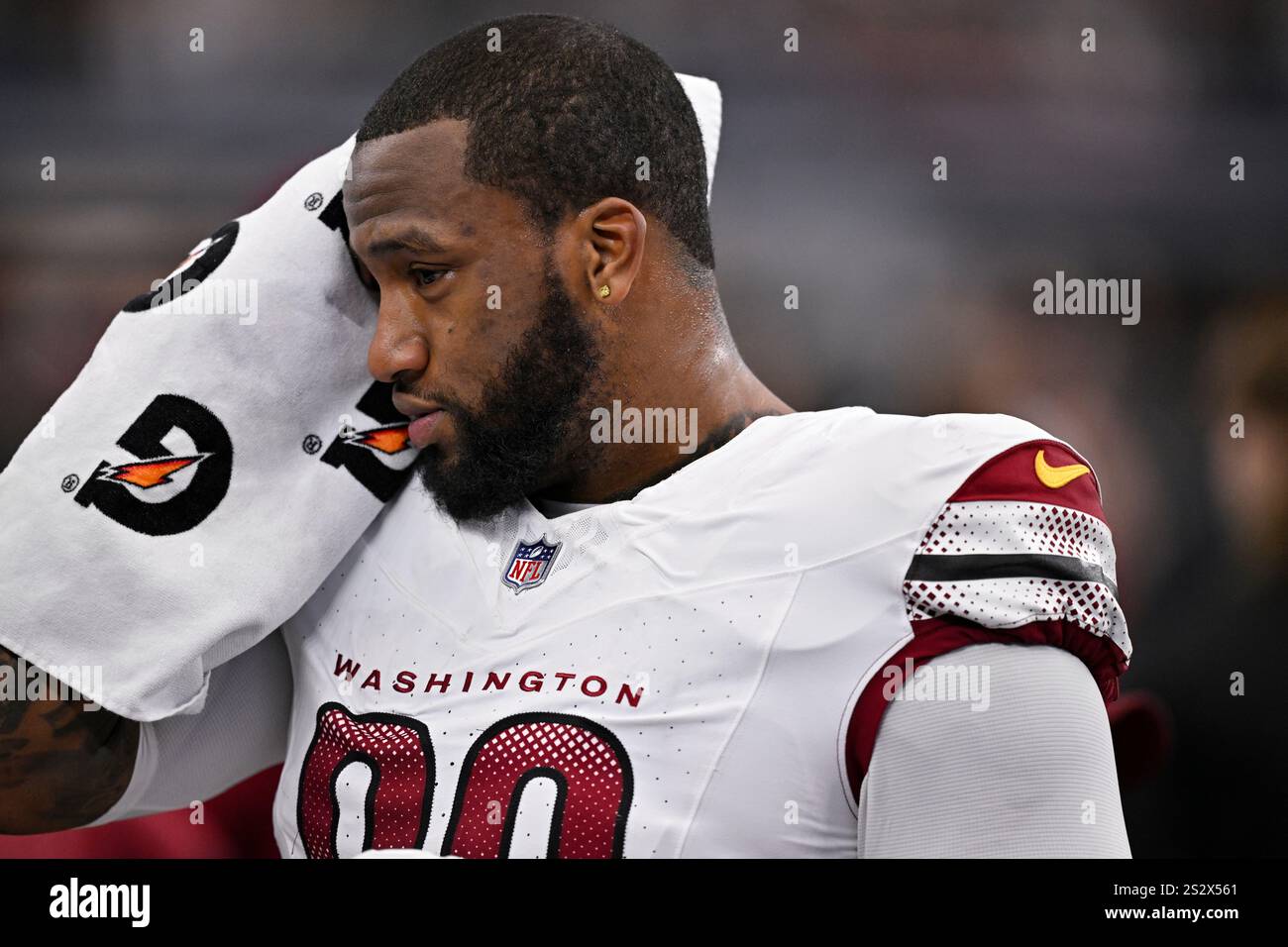 Washington Commanders defensive end Clelin Ferrell (99) uses a towel on ...