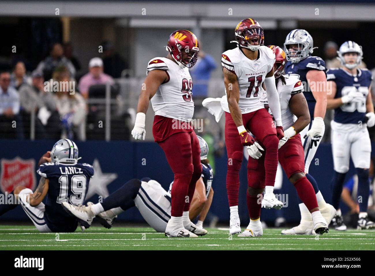 Washington Commanders safety Jeremy Chinn (11) and defensive tackle ...