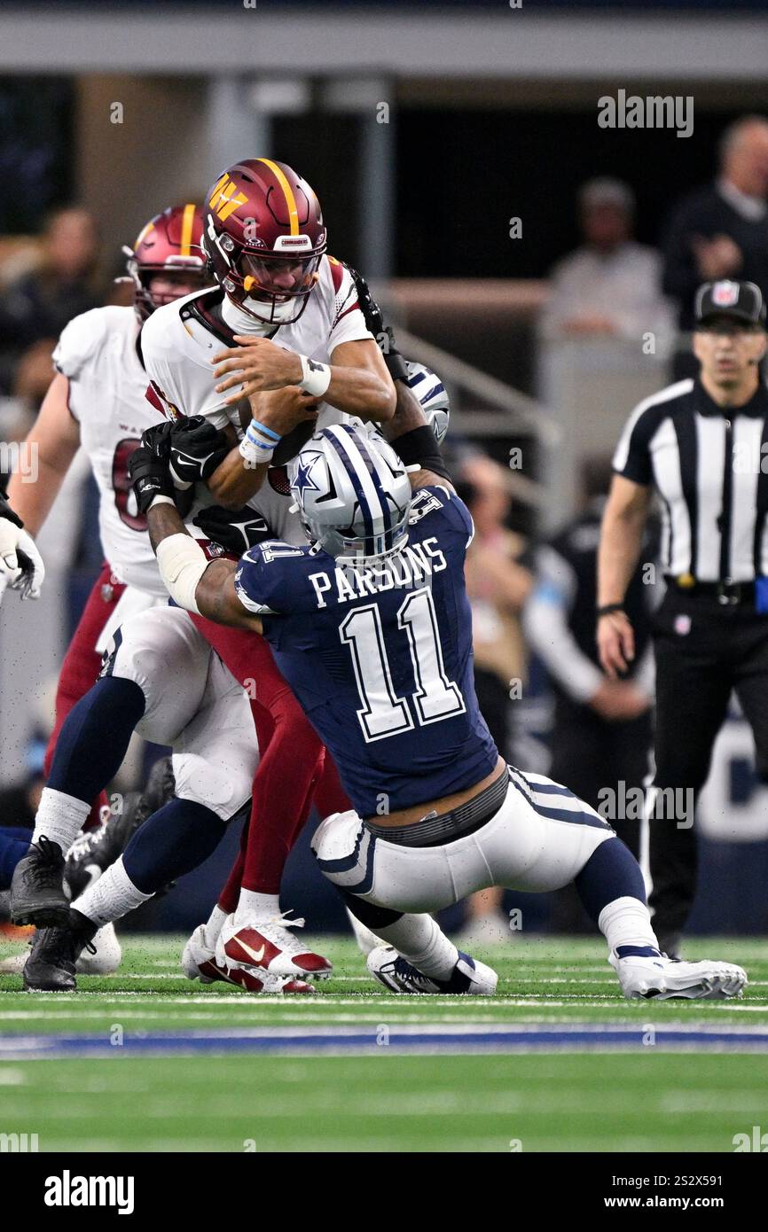 Washington Commanders quarterback Jayden Daniels (5) is tackled by ...