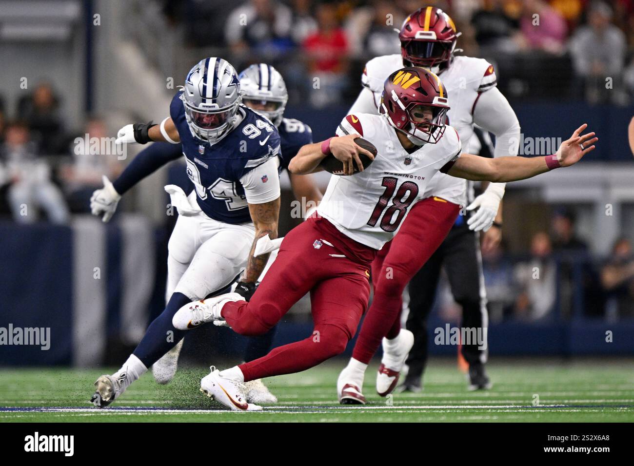 Washington Commanders quarterback Marcus Mariota (18) eludes the rush ...