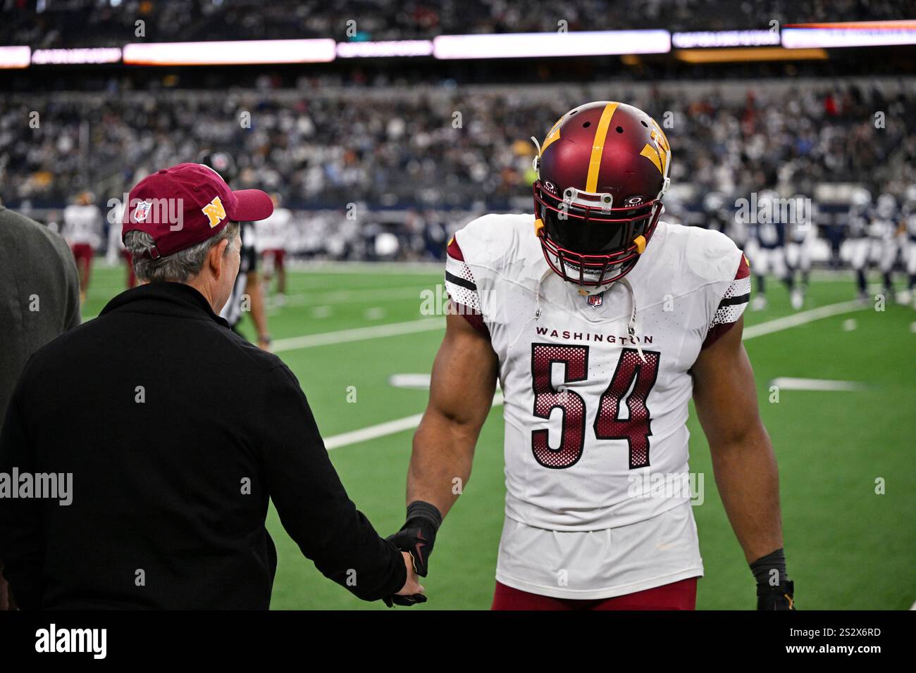 Washington Commanders owner Josh Harris (left) shakes the hand of ...