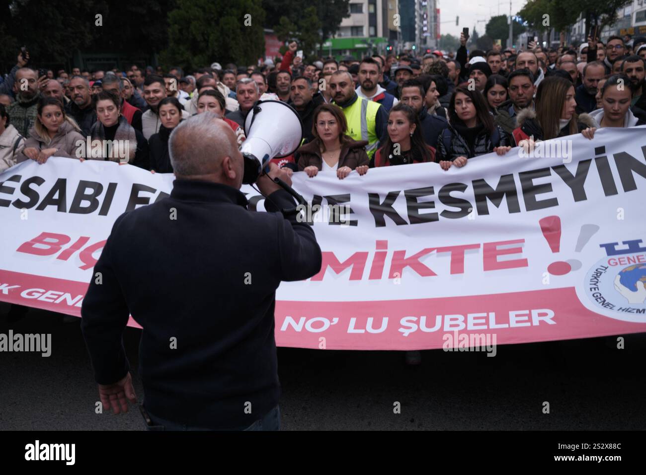 A trade unionist chants slogans on a megaphone during the rally ...