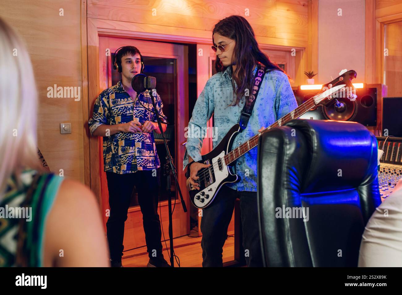 Portrait of professional male musicians standing at music recording ...