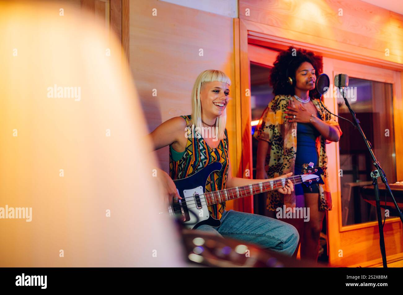 Smiling talented professional multicultural musicians making song at ...