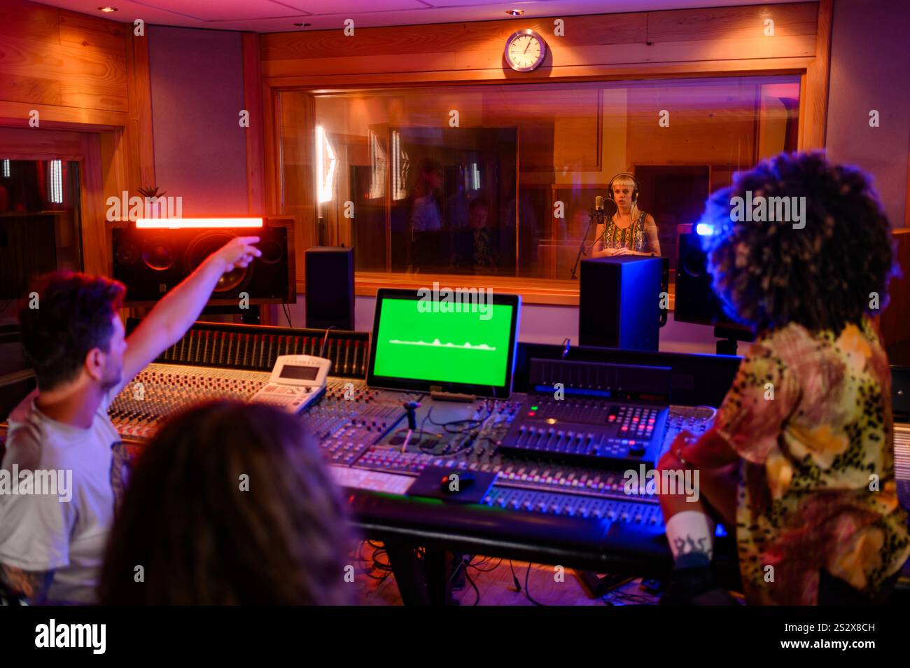 Multiracial music band performing and recording a new song album inside ...