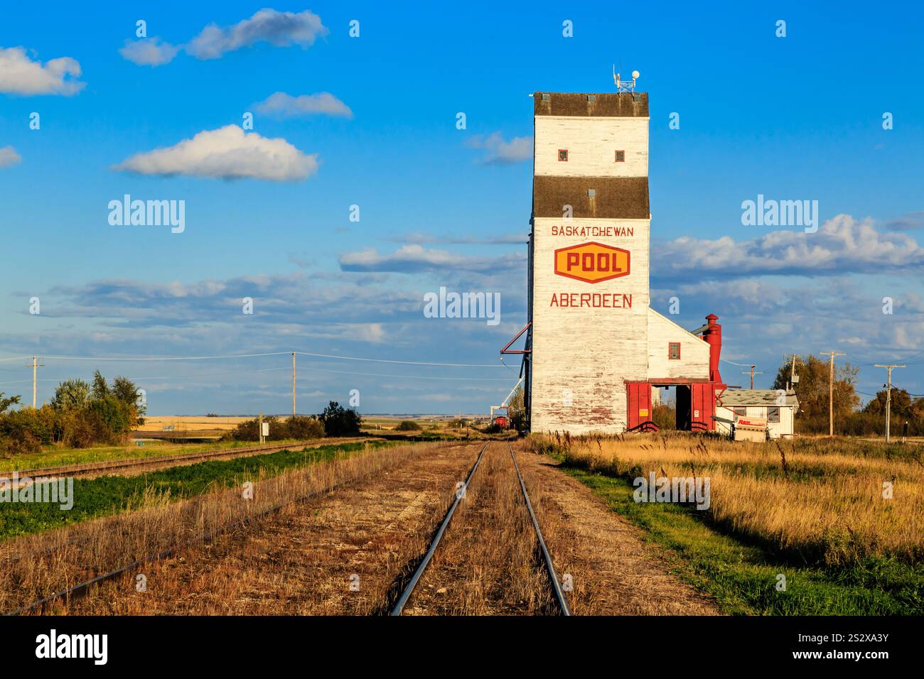 A large grain silo with a sign that says Pool. The silo is surrounded ...