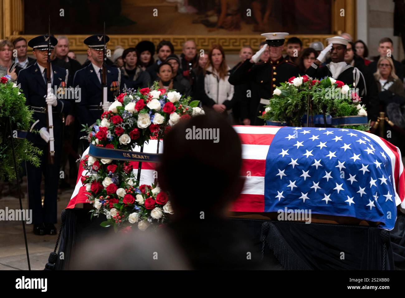 Mourners look at the flag-draped casket of former President Jimmy ...
