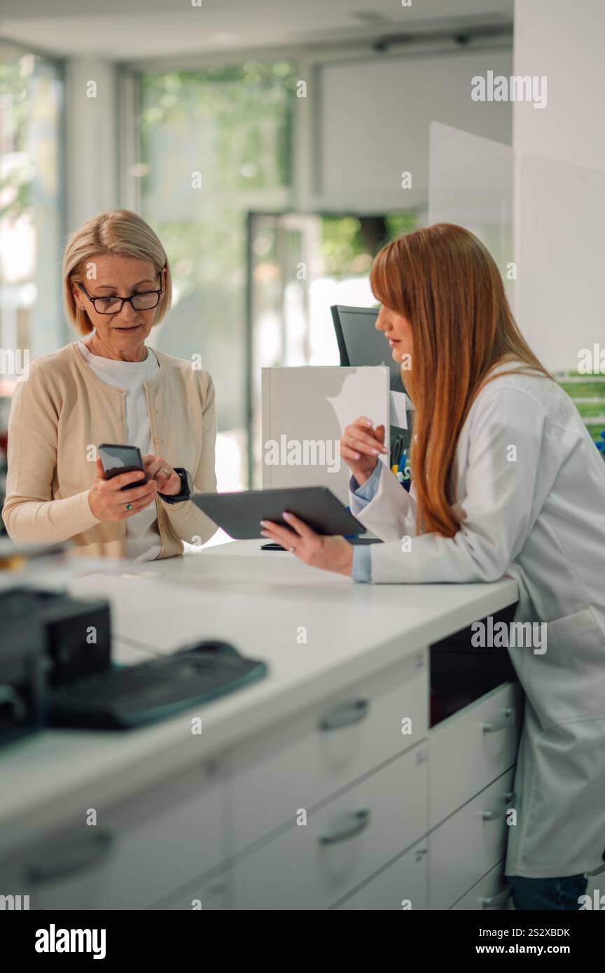 Professional friendly pharmacy shop worker behind counter at apothecary ...