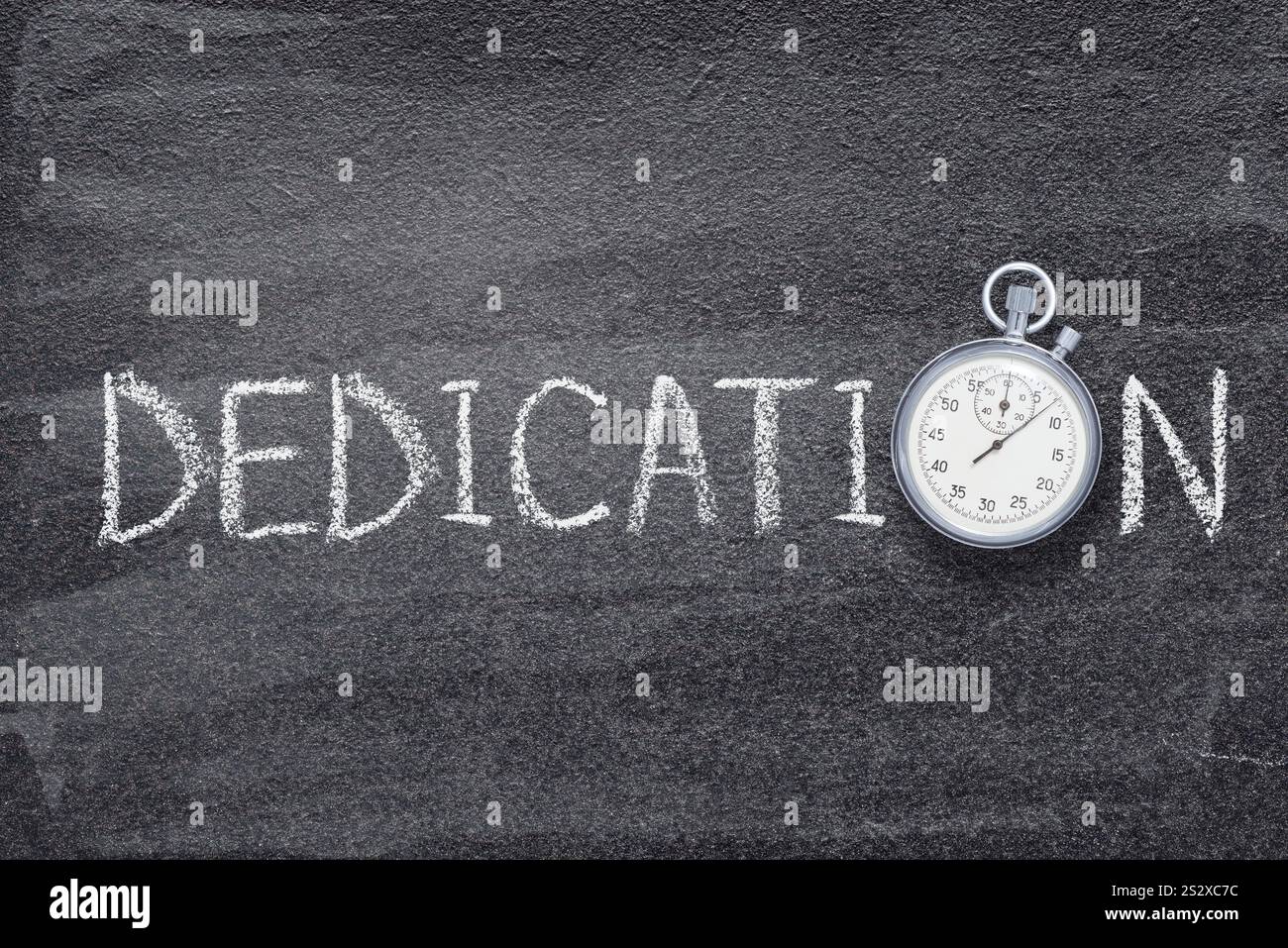 dedication word written on chalkboard with vintage precise stopwatch ...