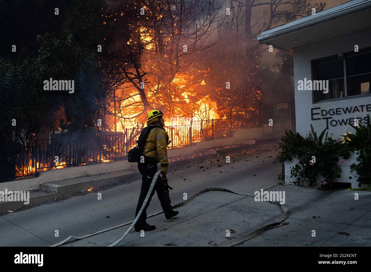 A Cal Firefighter fights the Palisades Fire. Palisades Fire burning ...