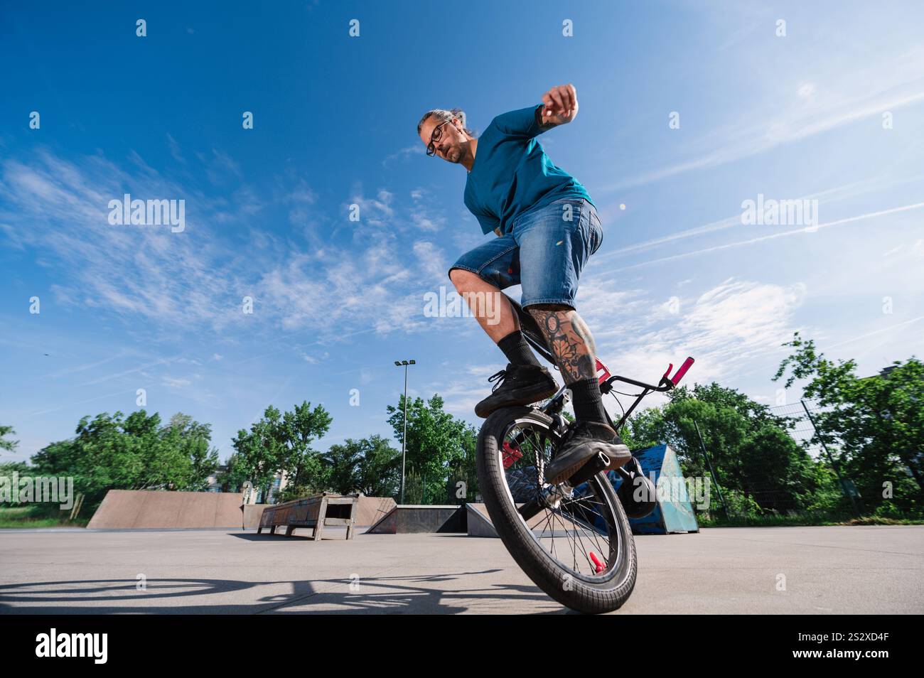 Low-angle view of an urban middle-aged master practicing a freestyle ...