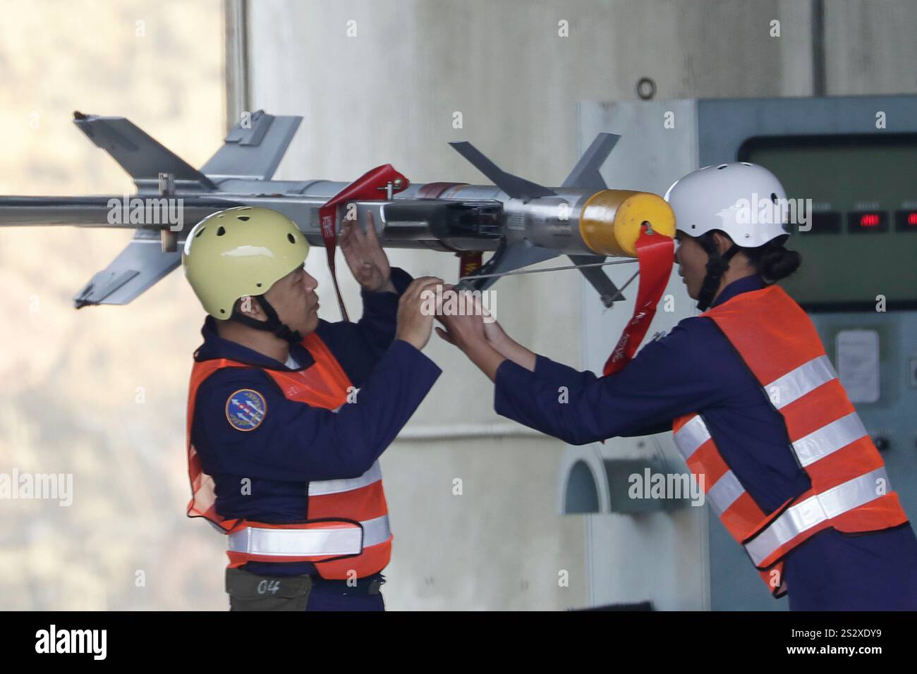 Soldiers check an AIM-9P4 Sidewinder short-range air-to-air missile as ...