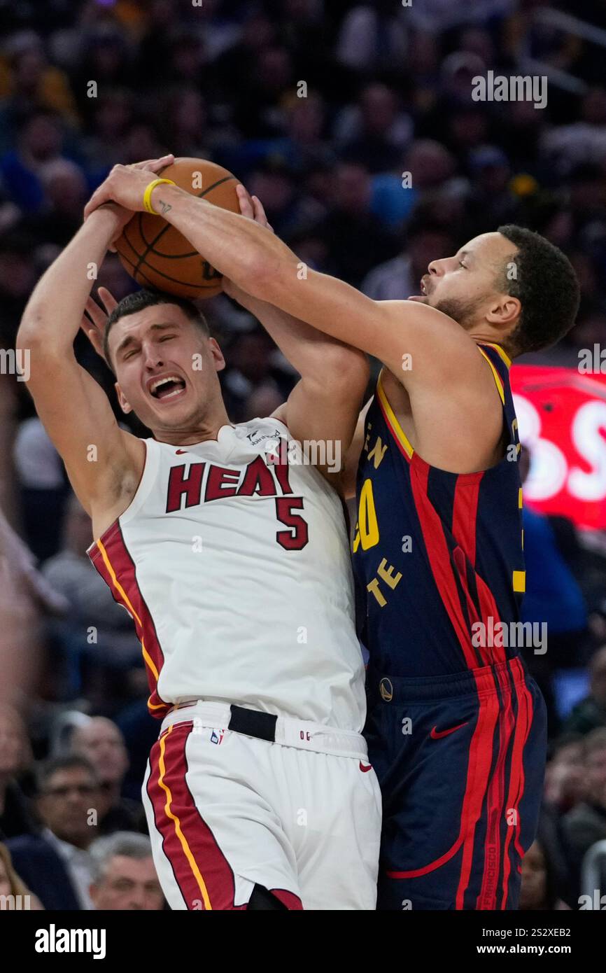 Miami Heat forward Nikola Jovic, left, and Golden State Warriors guard ...