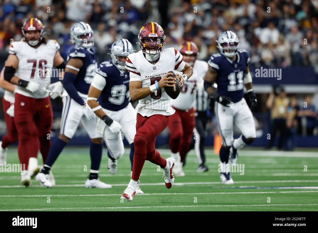 Washington Commanders quarterback Jayden Daniels (5) carries the ball ...