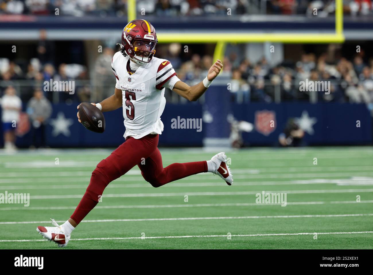 Washington Commanders quarterback Jayden Daniels (5) carries the ball ...