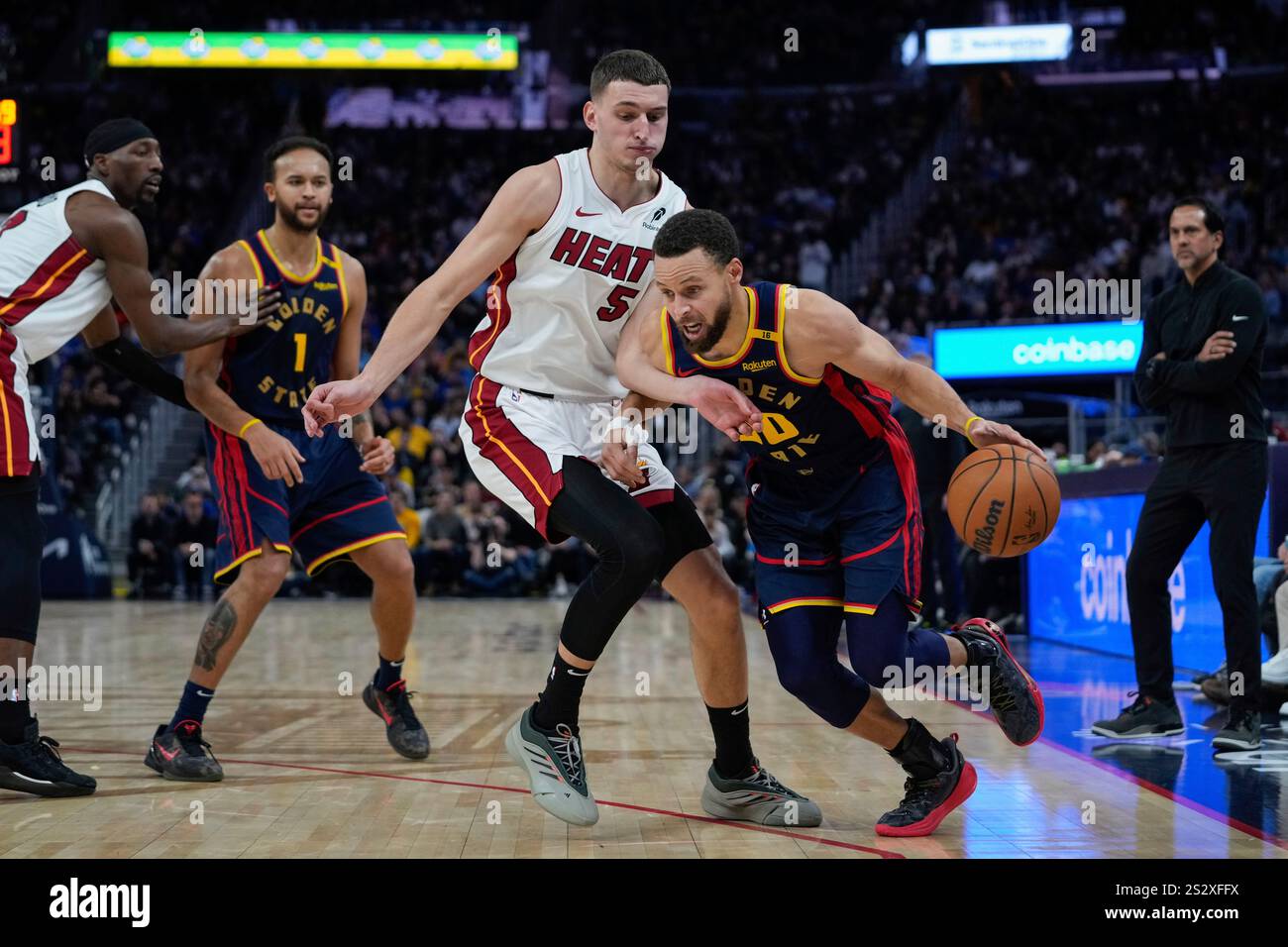 Golden State Warriors guard Stephen Curry, right, moves the ball while ...