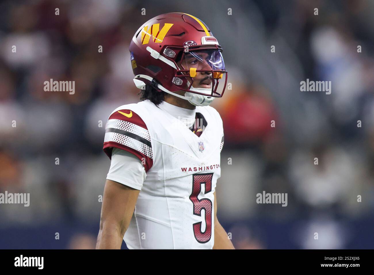 Washington Commanders quarterback Jayden Daniels looks to the sideline ...