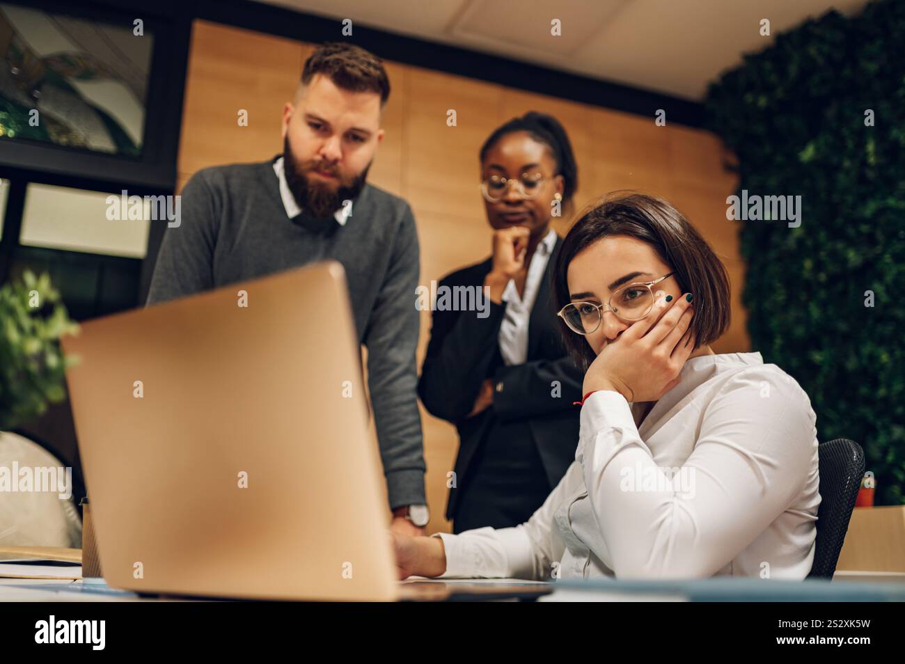 Stressed annoyed office employee manager having headache migraine at business meeting with his ...