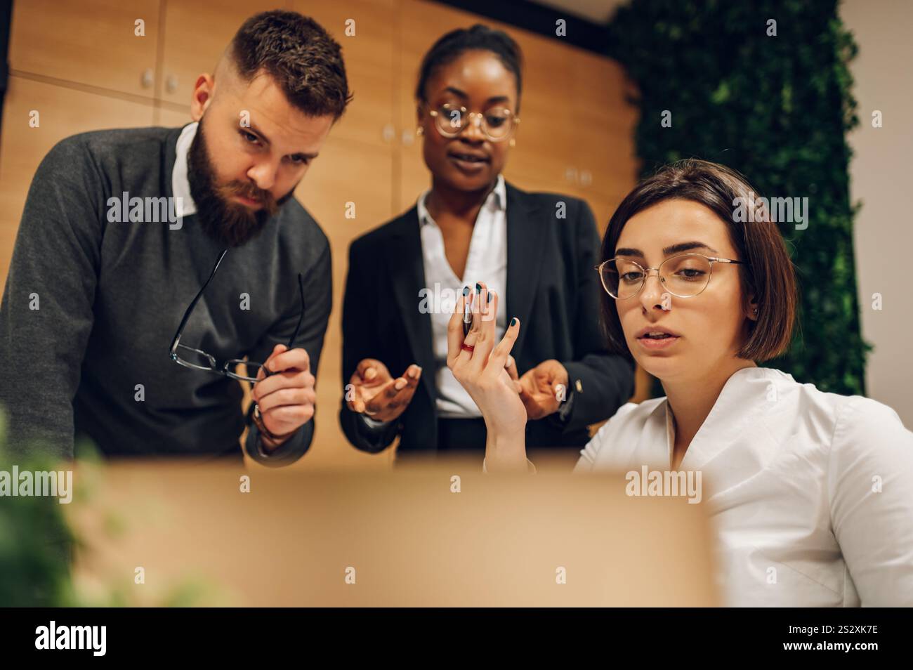 Cheerful diverse office colleagues having fun talking and enjoying ...