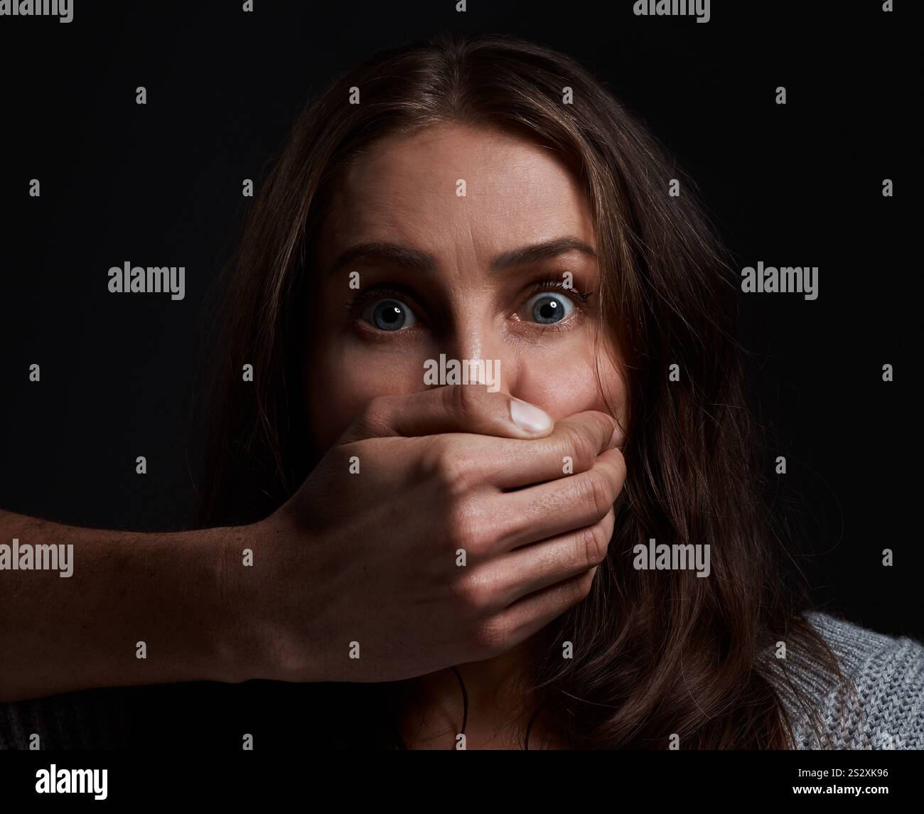 Studio, woman and scared with hand for abuse, domestic violence and ...