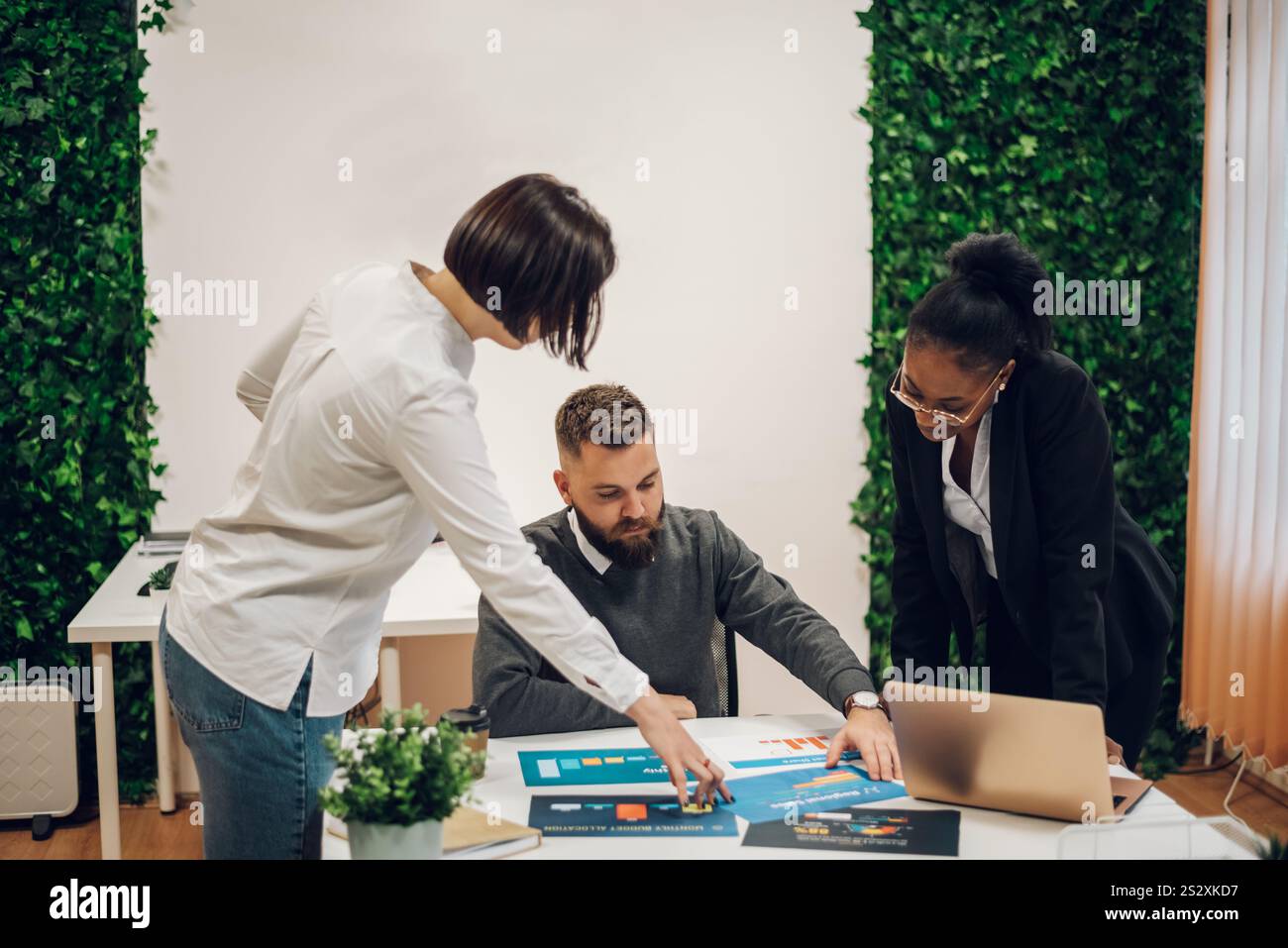 Young multiracial colleagues discussing a start up idea or a new ...