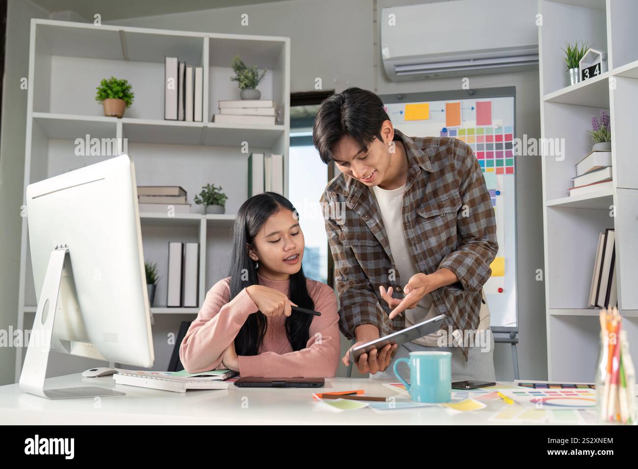 Design team meeting on color graphics and charts in a modern workspace ...