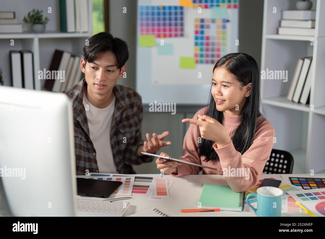 Team discusses color chart graphics design in creative meeting ...