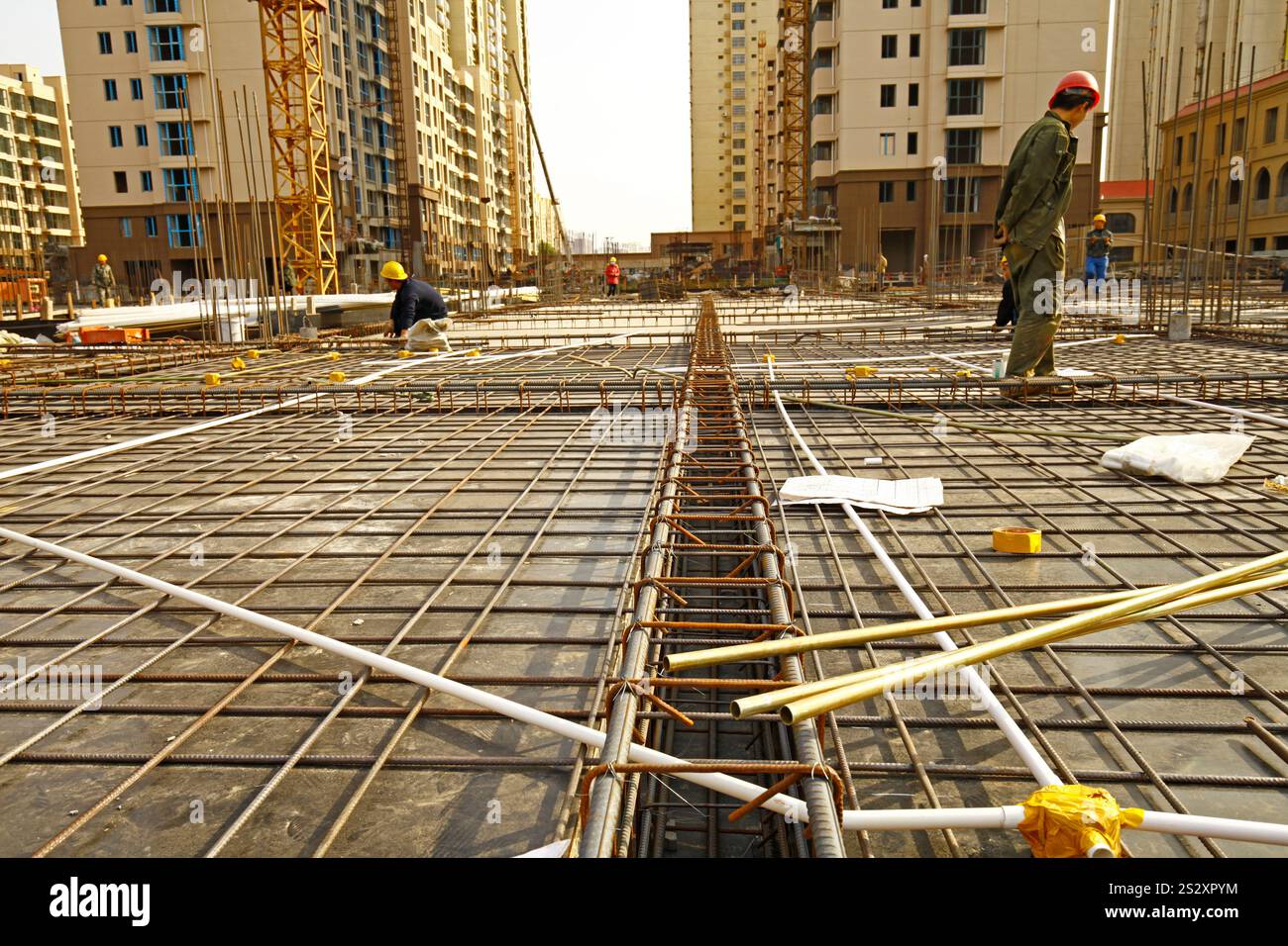worker in the construction site making reinforcement metal framework ...