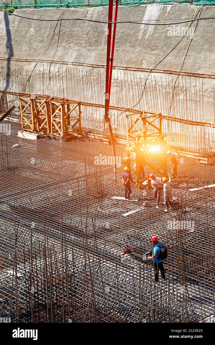 worker in the construction site making reinforcement metal framework ...
