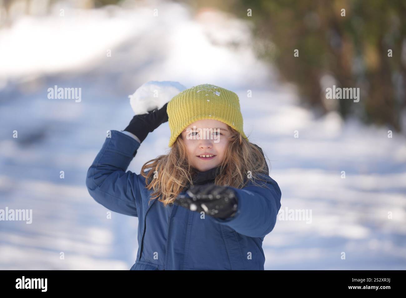 Child play with snow outdoors during first snowfall. Winter activities ...