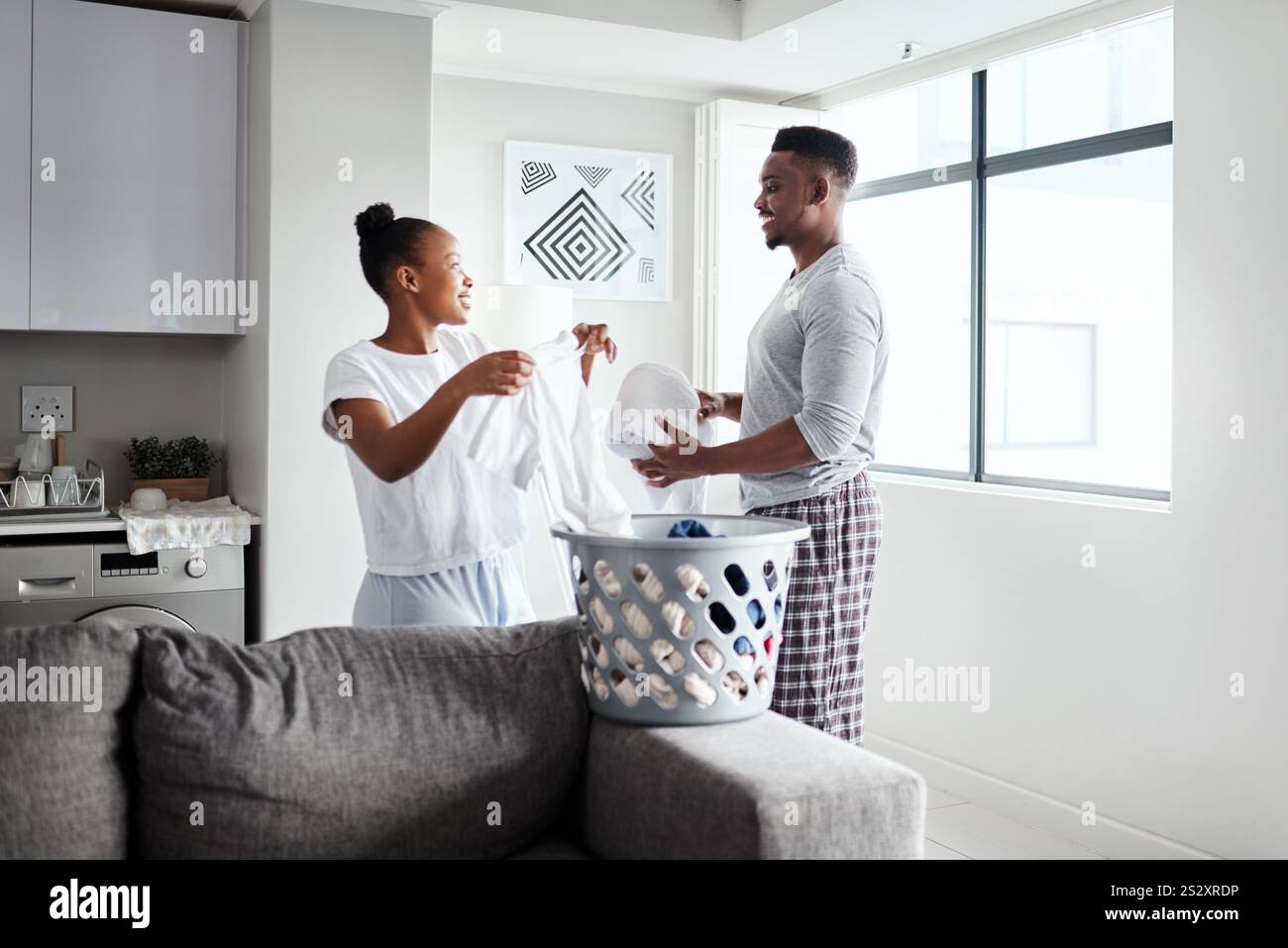 Black couple, laundry basket and love in home, sorting clothes and ...
