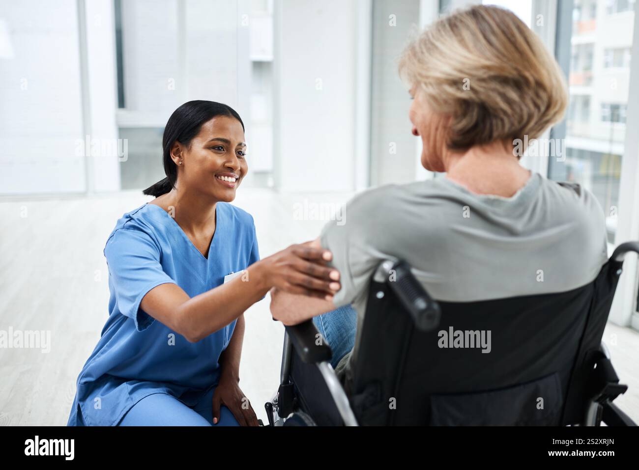 Caregiver, comfort and elderly woman in wheelchair of rehabilitation ...