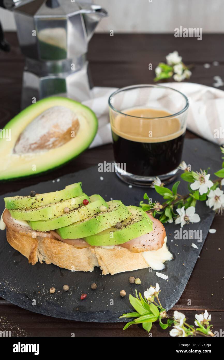Healthy breakfast. Toasted grain bread with fresh sliced avocado, ham ...