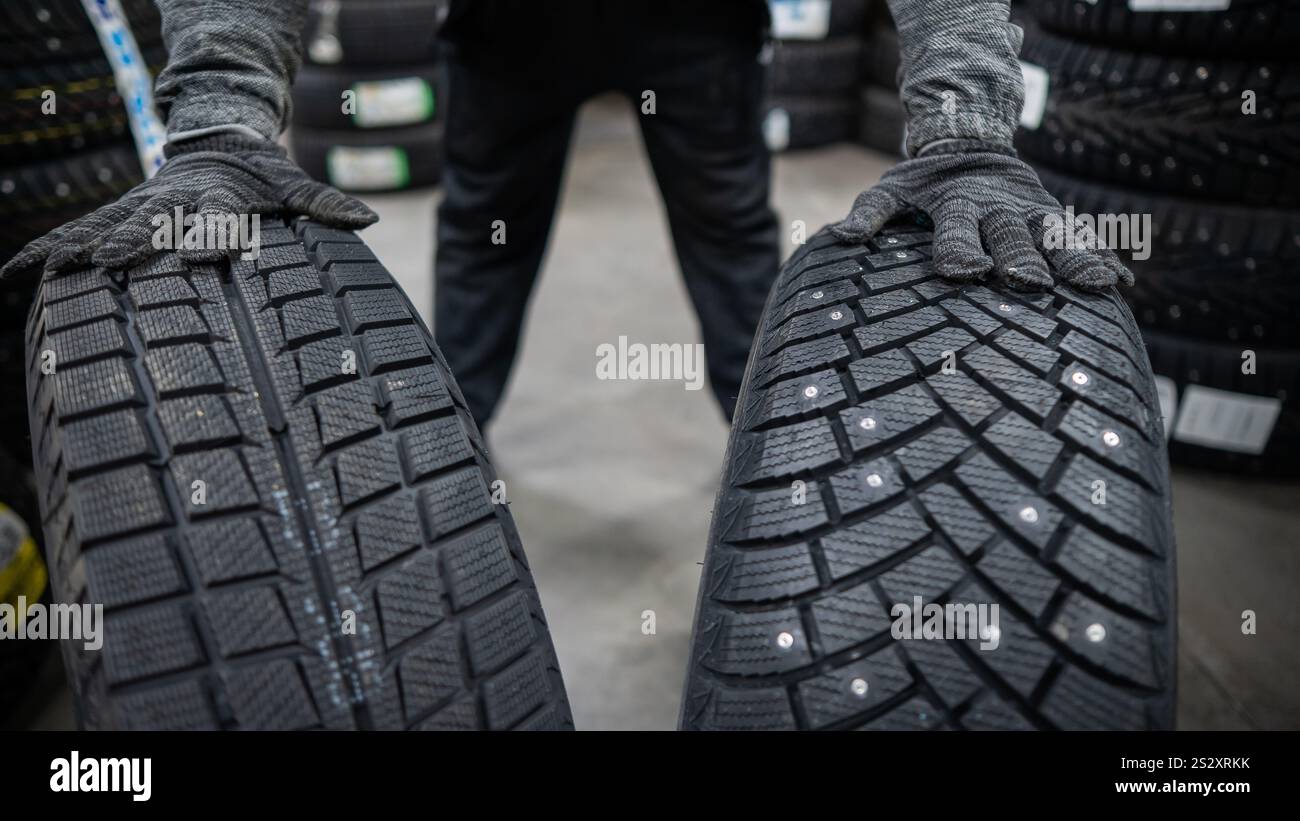 Mechanic keeps new summer and winter car tires in the garage. Comparison of wheels for different ...