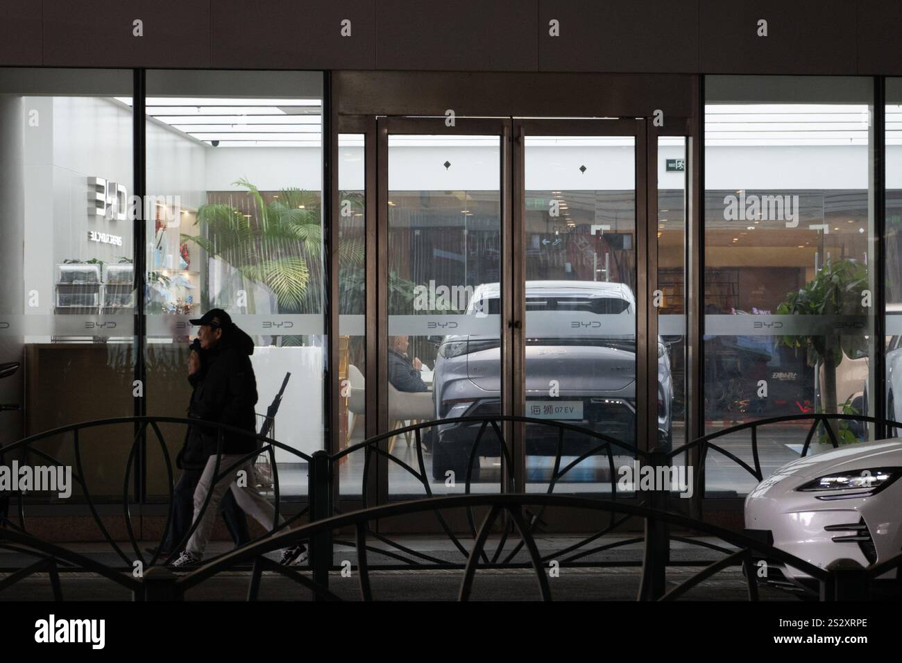 SHANGHAI, CHINA - JANUARY 8, 2025 - A pedestrian passes a BYD flagship ...