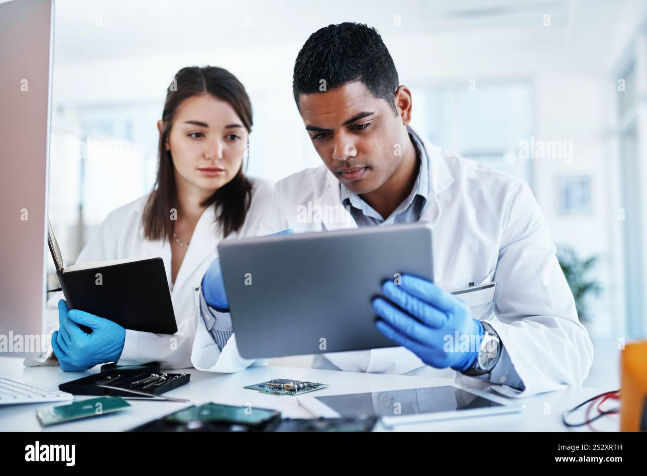 Lab, engineer and people with tablet, serious and collaboration for ...
