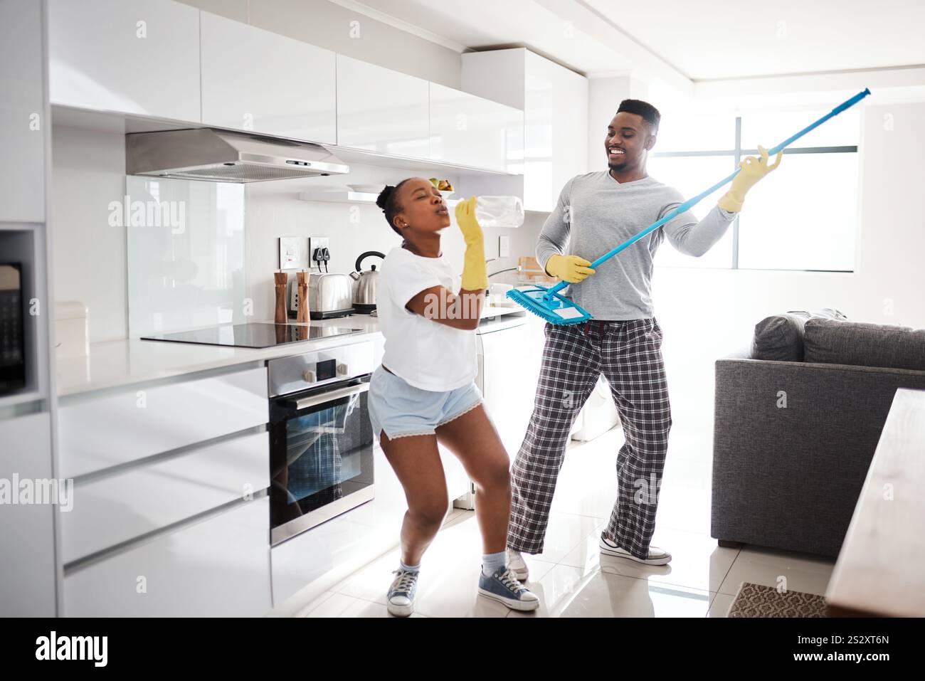 Black couple, singing and cleaning together in home, disinfection and ...
