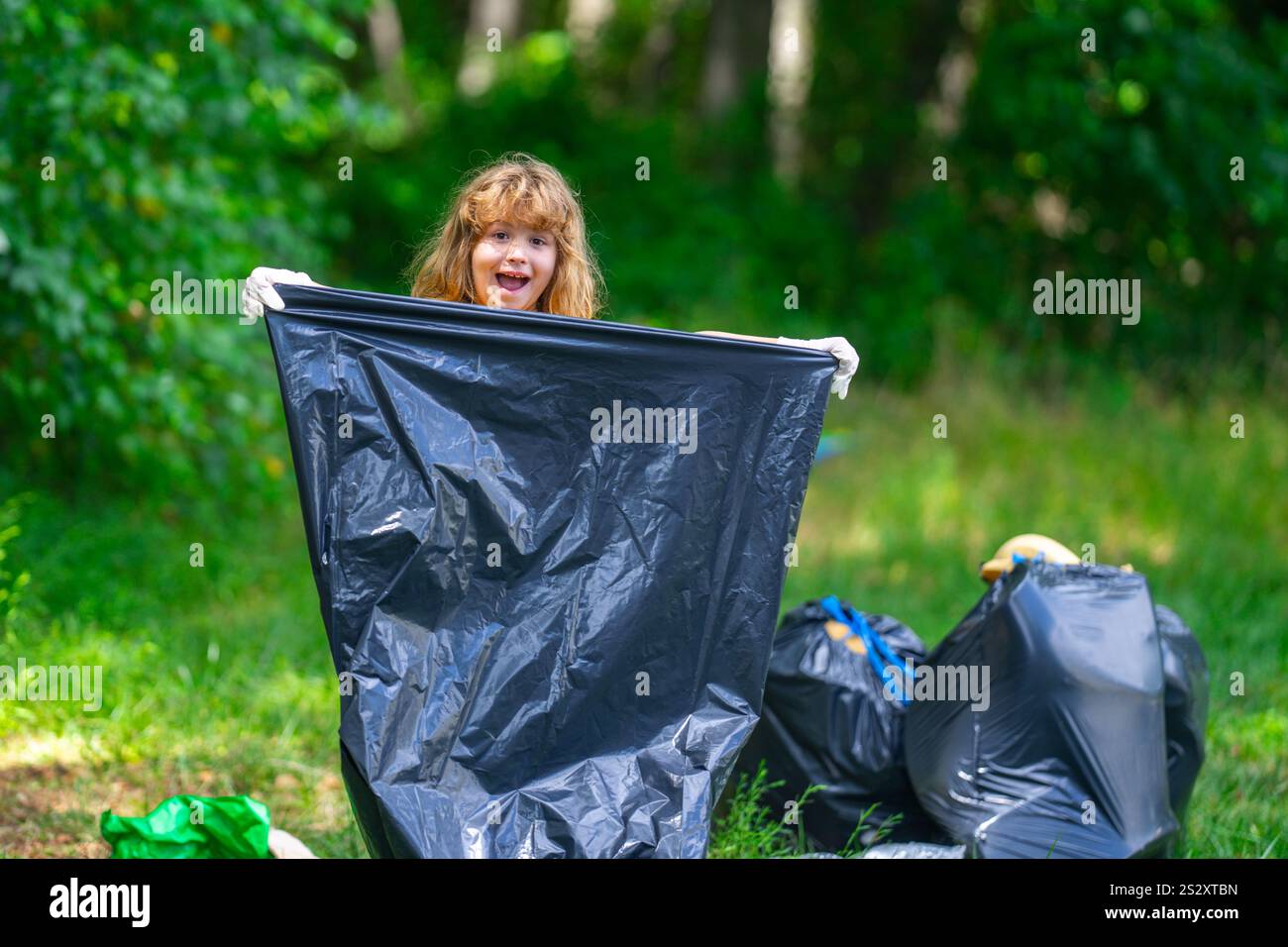 Child collecting trash outside. Ecology concept. Environmental ...