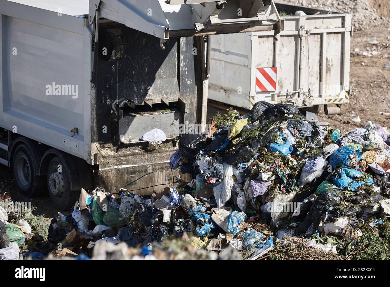 Trucks unloading garbage on an open air dump. Waste recycling Stock ...