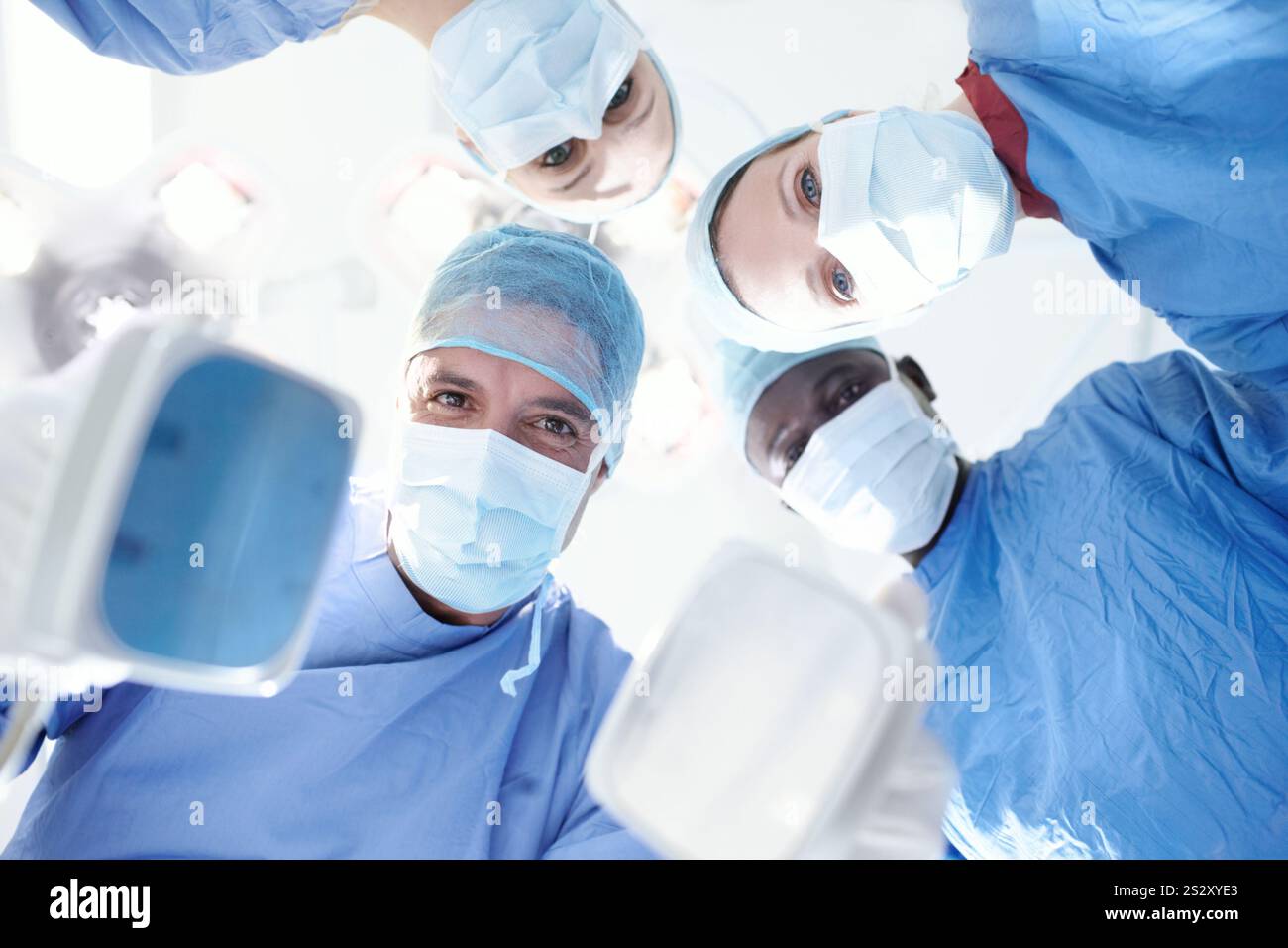 Doctors, defibrillator and machine in surgery in theatre of cardiology ...