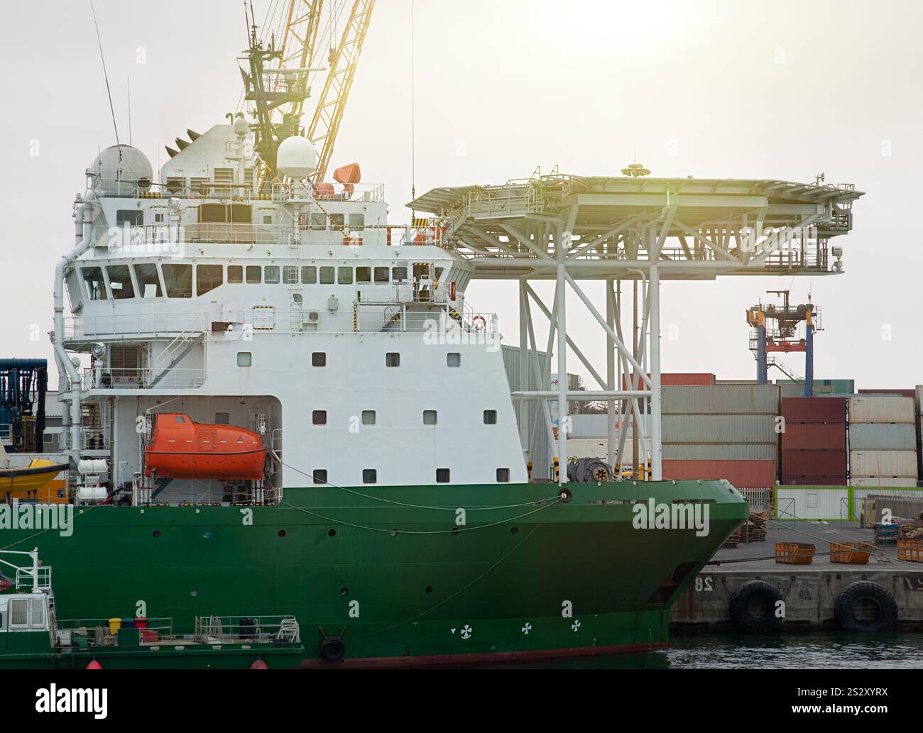 Specialized offshore support vessel with helipad docked at industrial ...